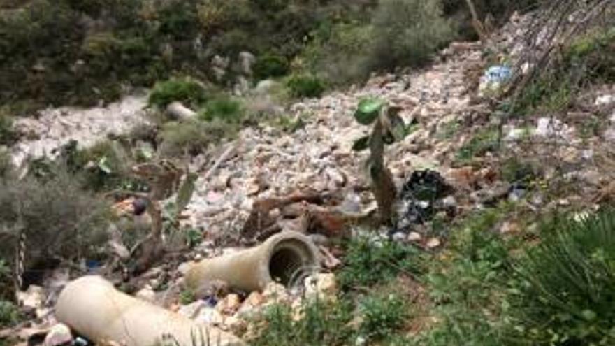 Tiran escombros en el talud que corona unas cuevas con arte rupestre de ...
